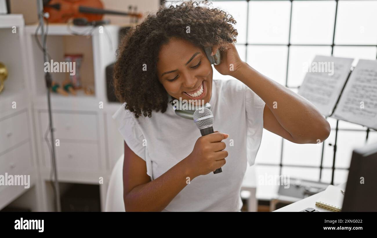 African american singer with braids performing in a music studio Stock ...