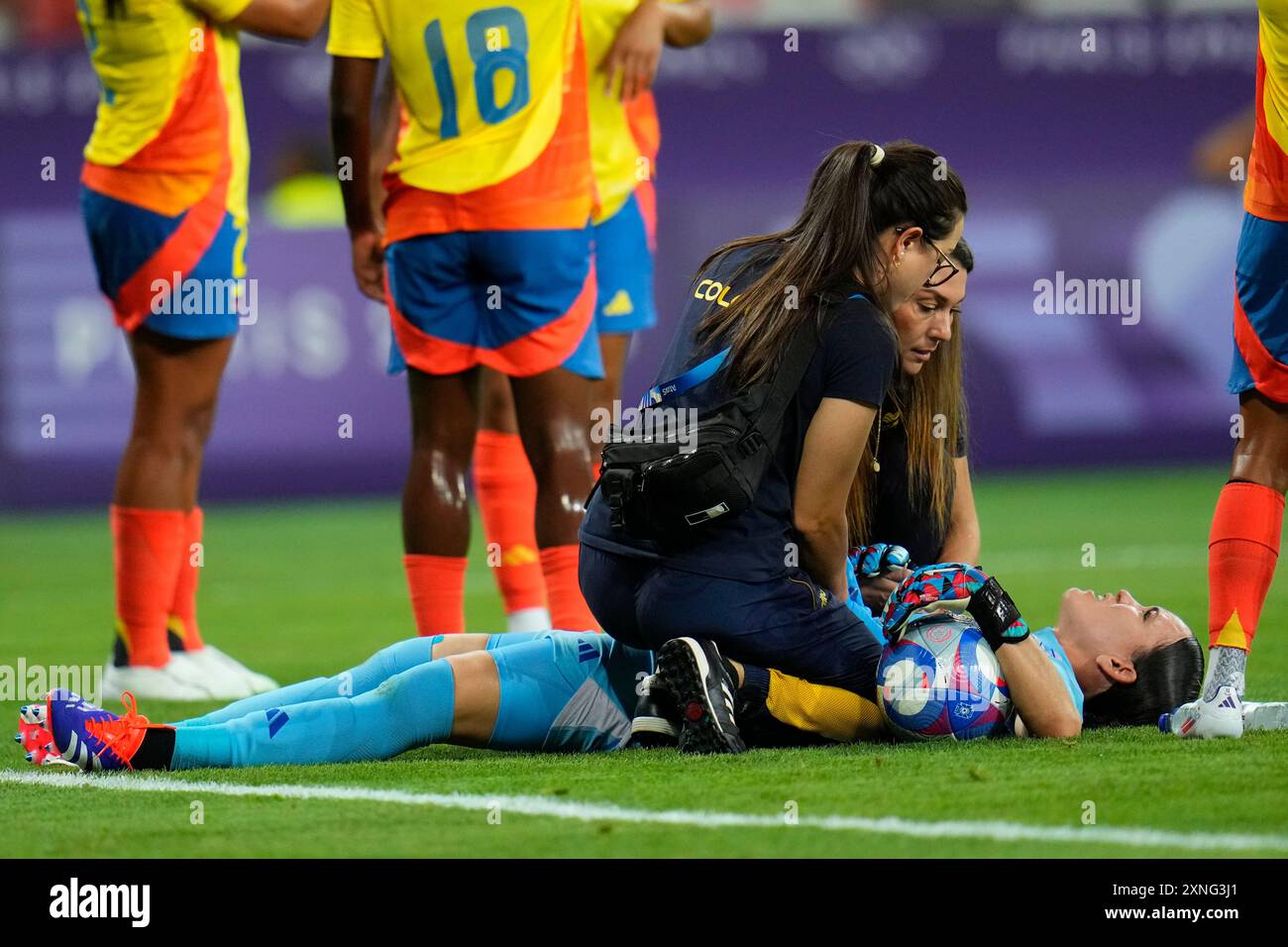 Colombia goalkeeper Katherine Tapia gets assistance as she lies on the ...