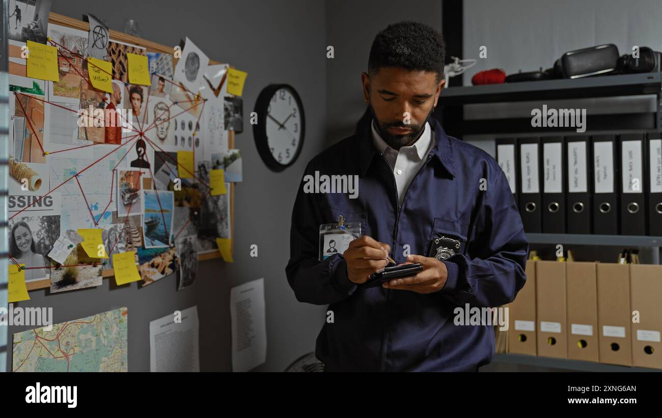 A focused young african american man with a beard taking notes in a ...