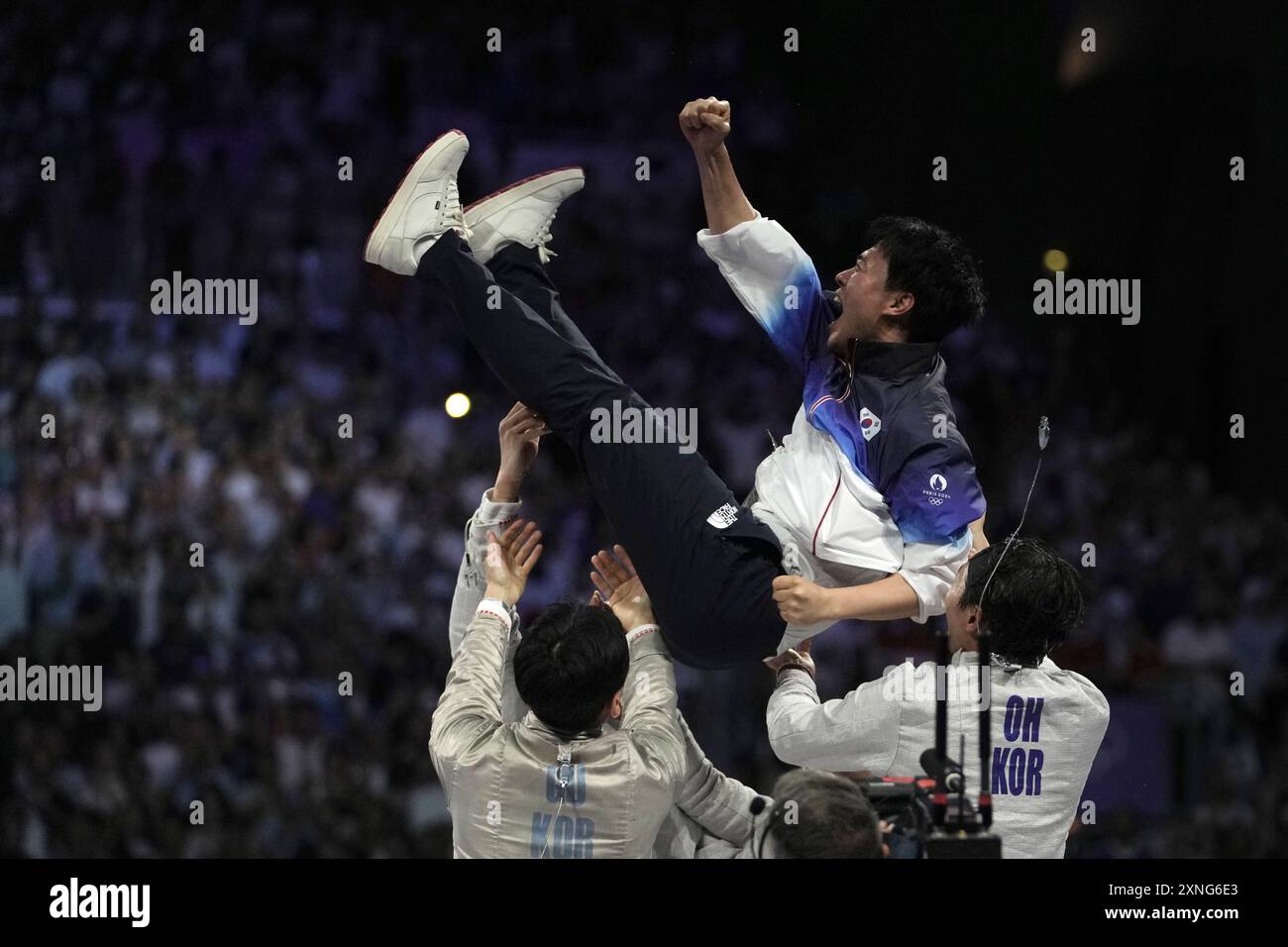 South Korea's fencer celebrate with his coach, top, after winning the ...