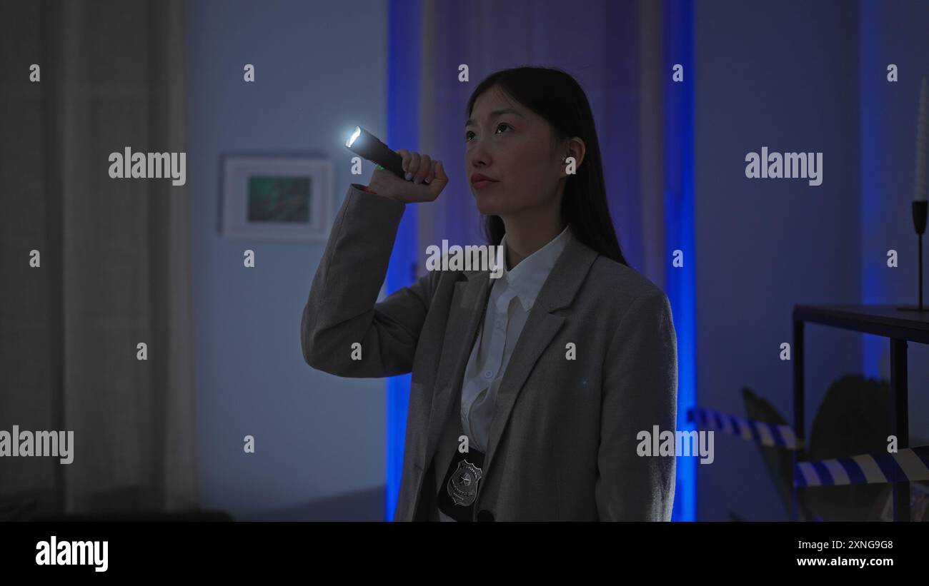 A chinese woman detective with a flashlight investigating a dark indoor ...