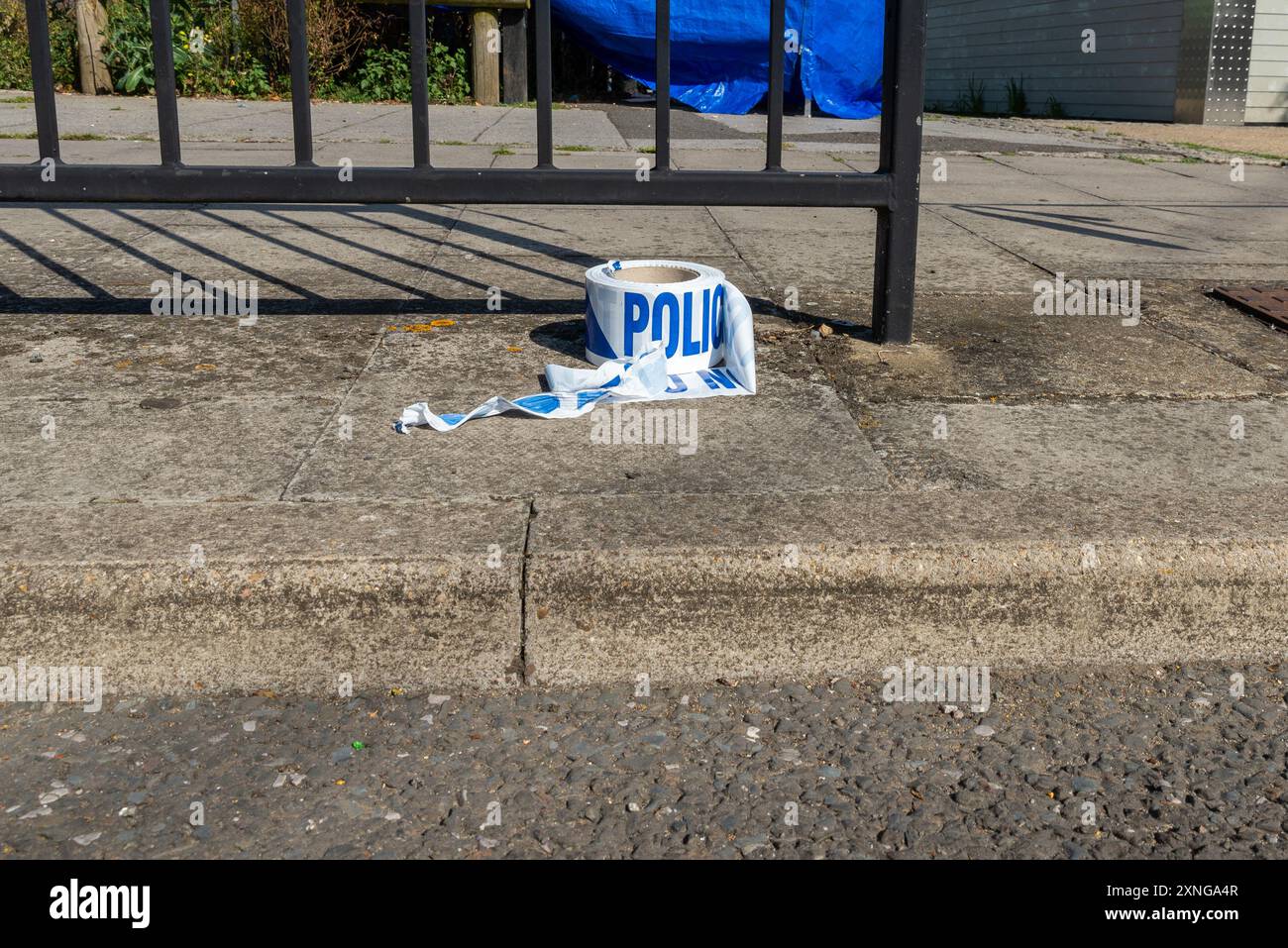 A roll of police incident tape ready to tape off a murder crime scene ...