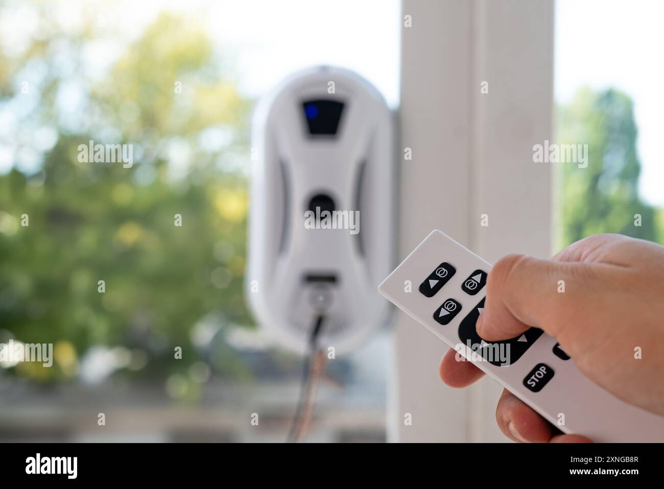 Remote control of a robotic window washer that washes glass from dirt ...