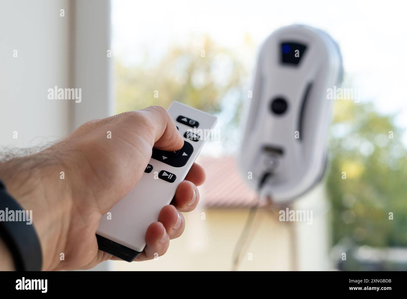 Remote control of a robotic window washer that washes glass from dirt ...