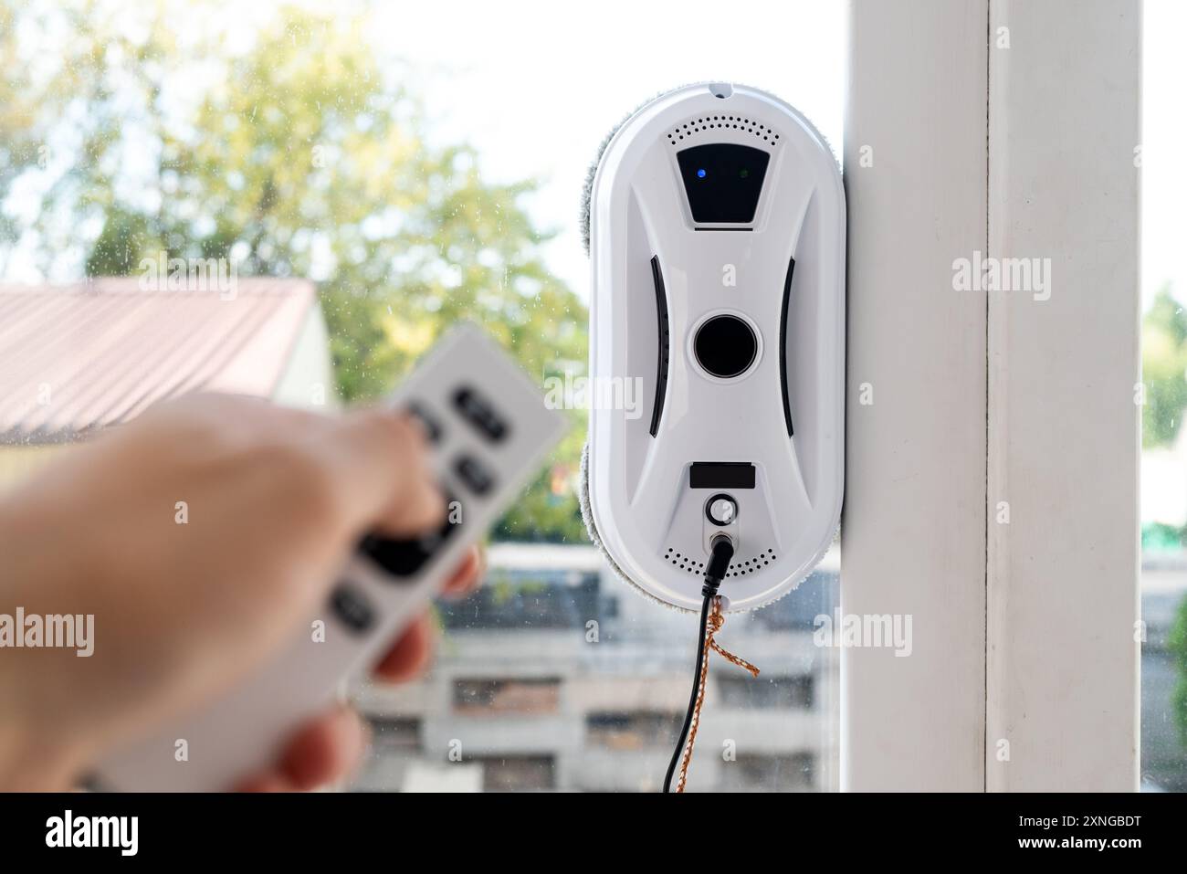 Remote control of a robotic window washer that washes glass from dirt ...