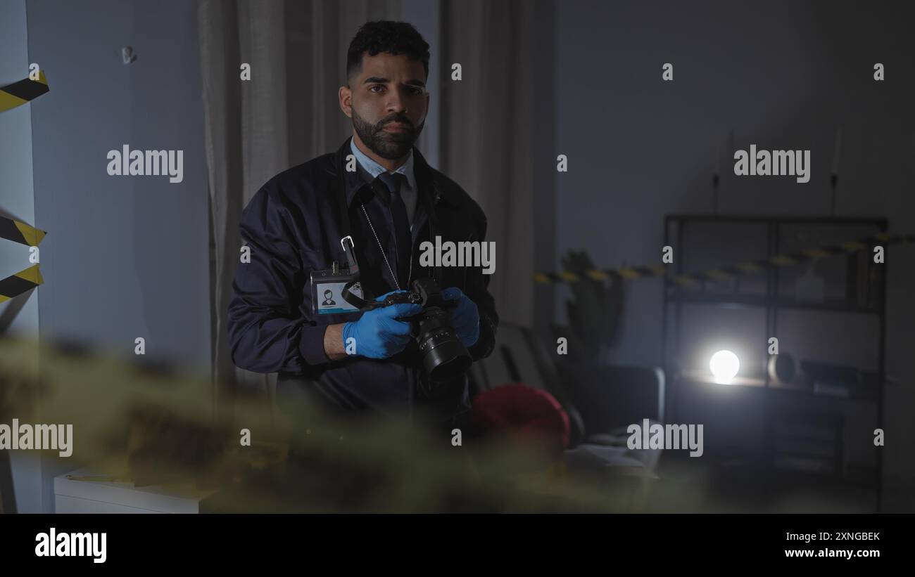 A hispanic man with a beard, holding a camera, stands in an apartment ...