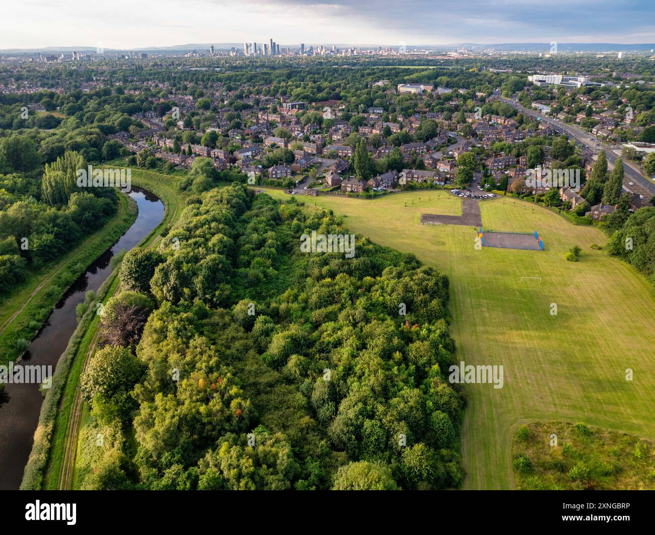 Aerial view of a park in Salford with a river Irwell, buildings, and a ...