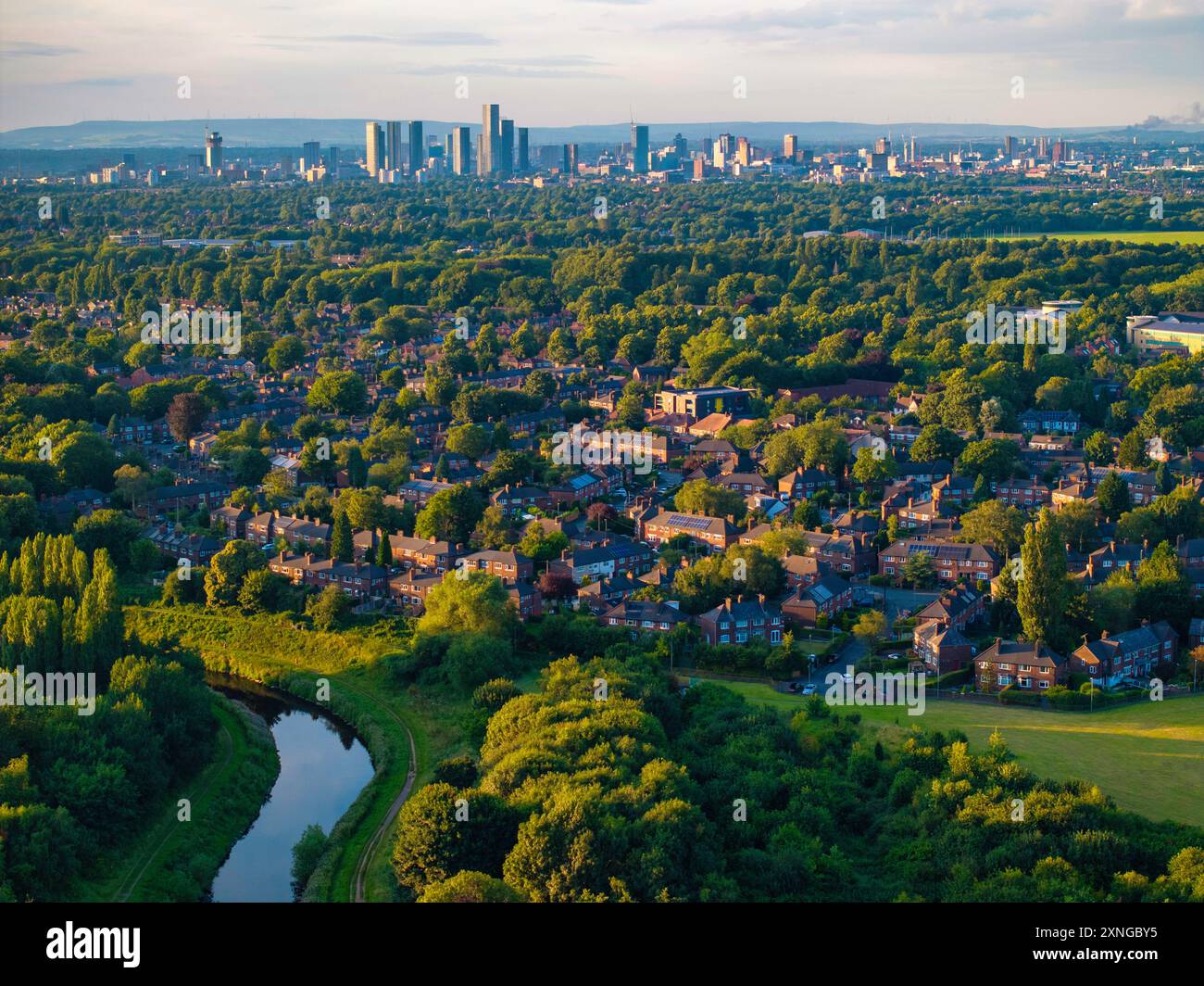 Aerial view of a suburban residential area with a city skyline in the ...