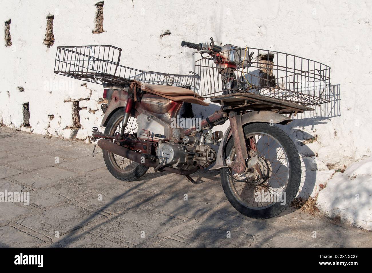 Old, rusty Scooter, parked up in Lindos on the Greek island of Rhodes ...