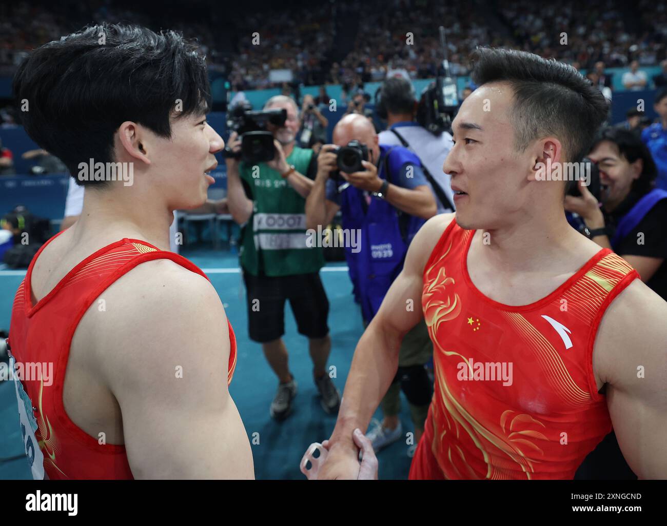 Paris, France. 31st July, 2024. Zhang Boheng (L) of China shakes hands ...