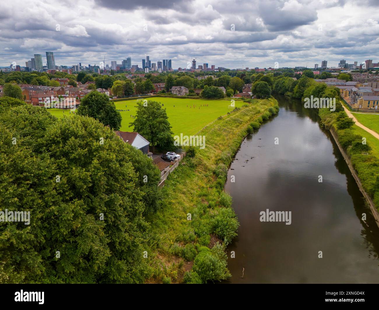 Aerial view of a park in Salford with a river Irwell, buildings, and a ...