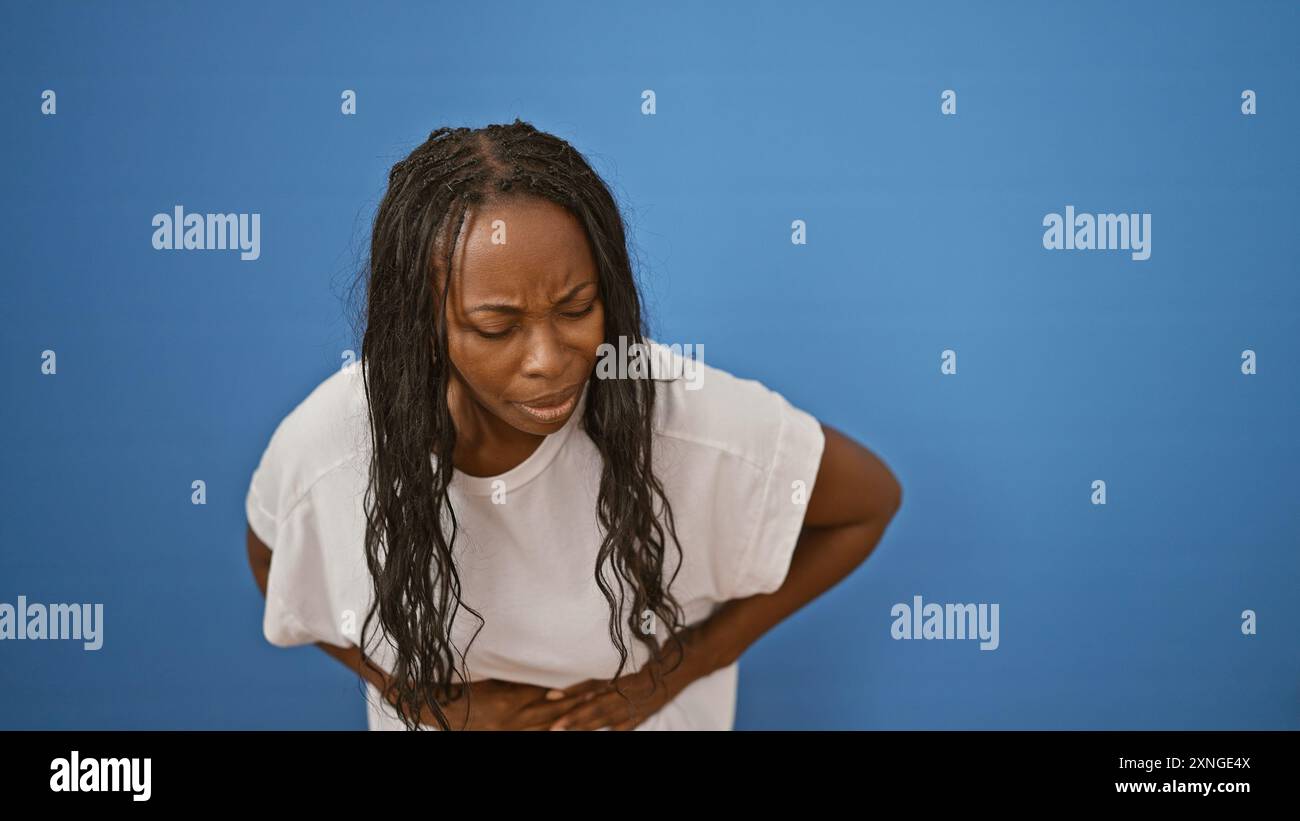 African american woman with curly hair expressing stomach pain isolated ...