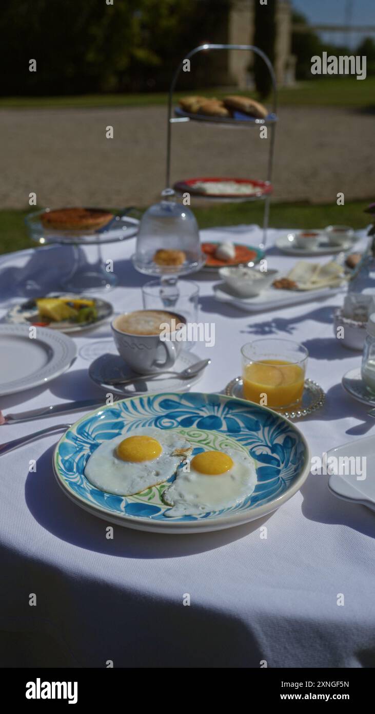 Outdoor table set with a colorful breakfast spread including eggs ...