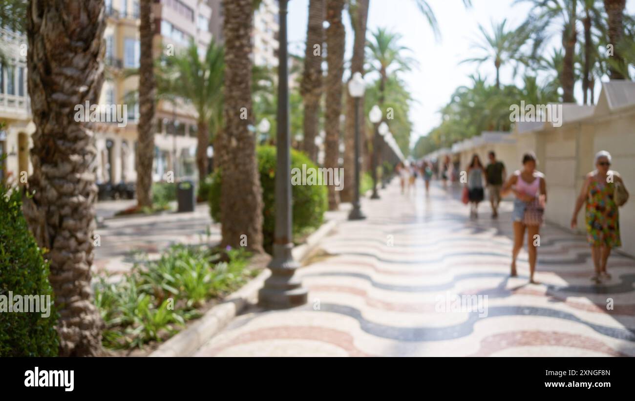 Blurred sidewalk scene featuring people walking on a tree-lined ...