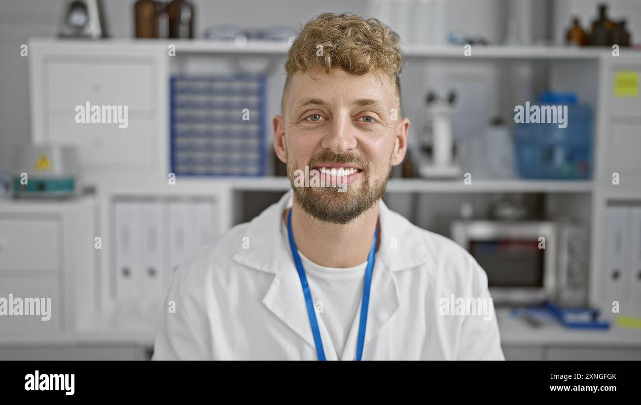 Caucasian male scientist with blue eyes and a beard smiles in a white ...