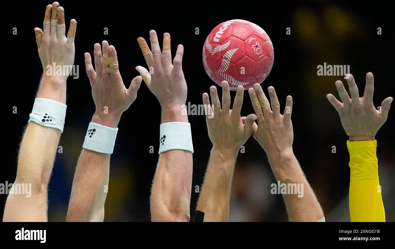 Sweden players try to block the shot of Borut Mackovsek, of Slovenia ...