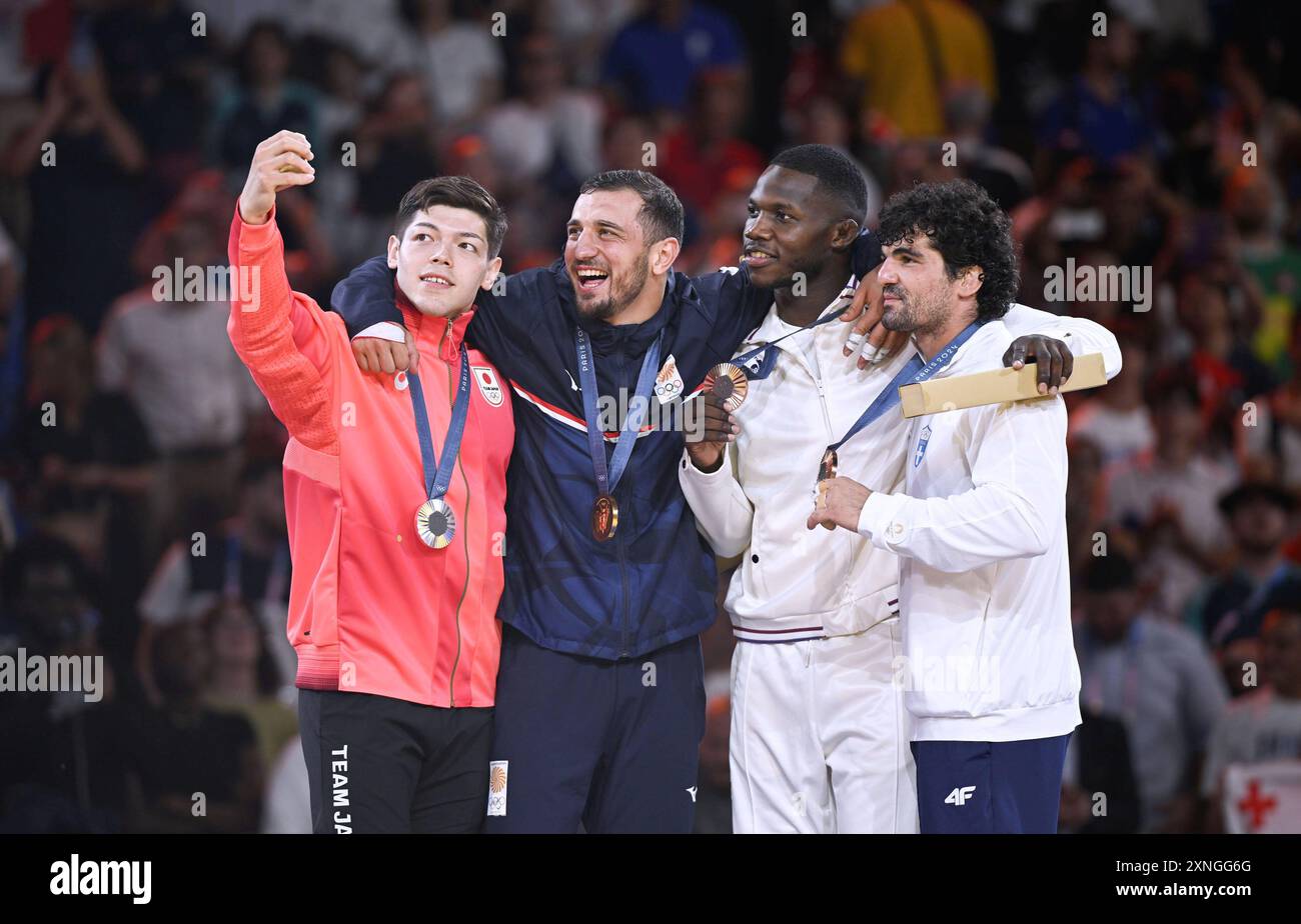 Lasha Bekauri (2nd from L) of Georgia poses for a photo after winning ...