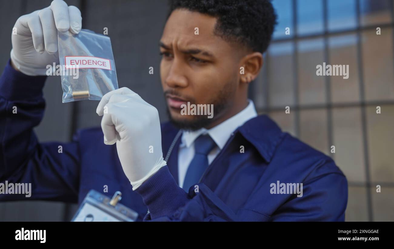 Focused african american man in formalwear examining a bullet in an ...