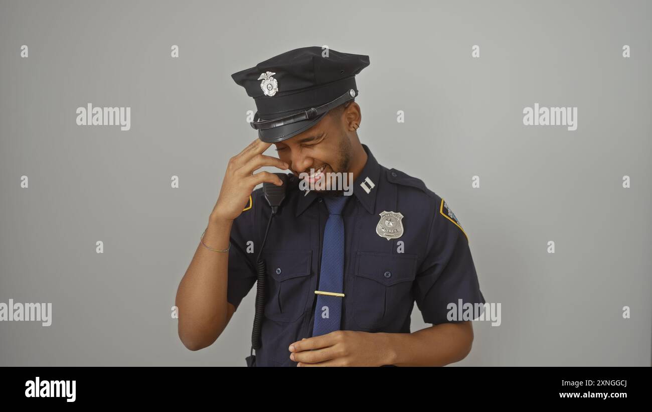 A distressed african american policeman communicating on his radio ...