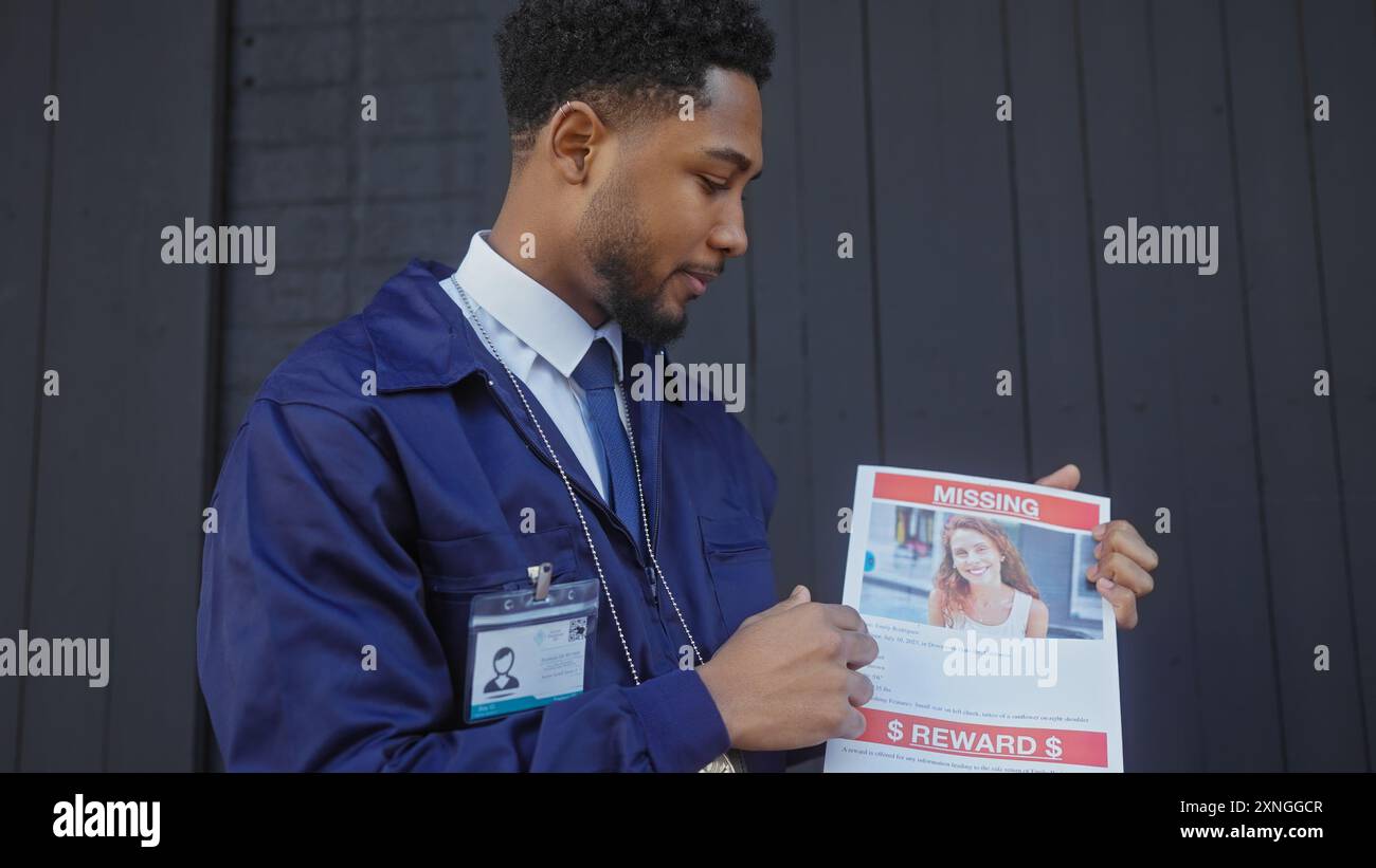 African american man in uniform holding a missing person flyer with a ...
