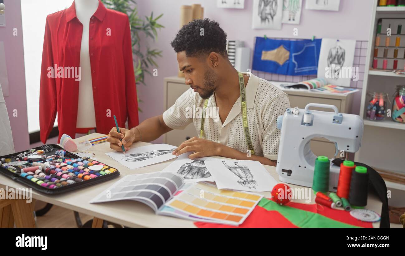 African american man working in tailor shop with sewing machine, fabric ...