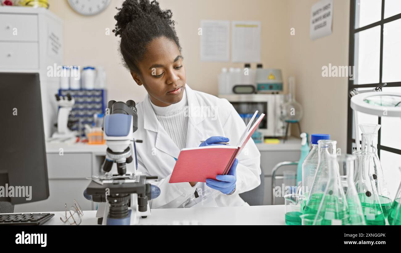 African american woman scientist reading notes in a laboratory setting ...