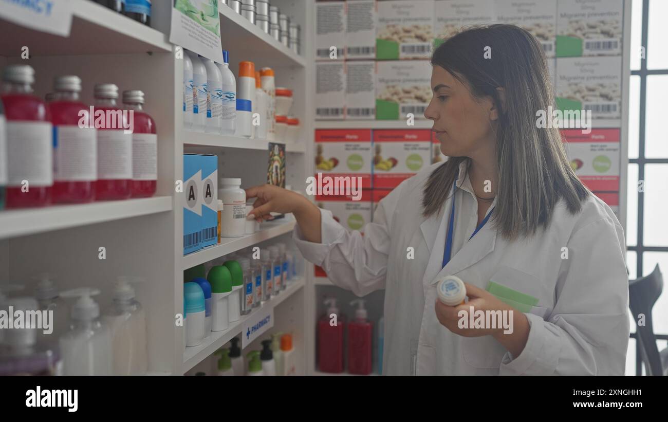 Adult woman pharmacist organizing medication shelves in a modern ...