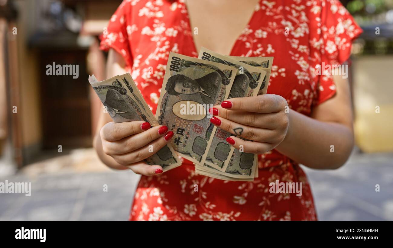 Young woman's hands, busy counting yen banknotes in the traditional ...