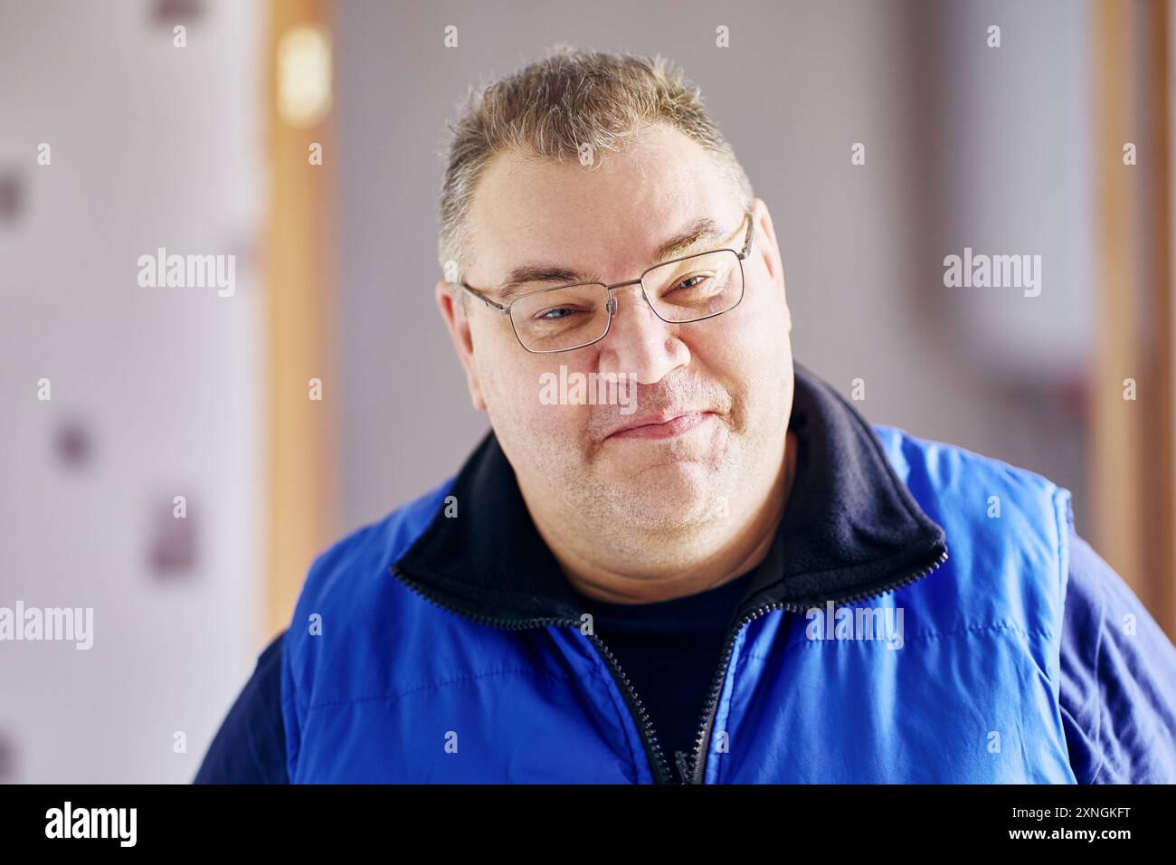 Fat man tries to hold back smile on his cheeky face Stock Photo - Alamy