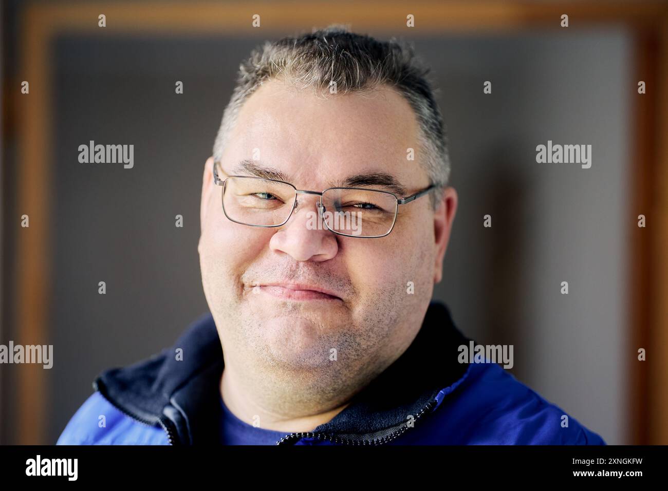 Cheeky face of large man in glasses in her 40s Stock Photo - Alamy