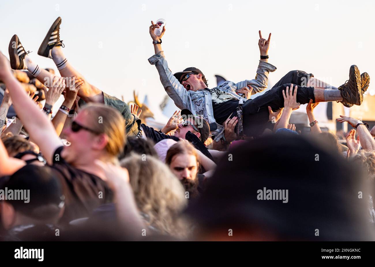 Wacken, Germany. 31st July, 2024. Festival-goers celebrate while ...