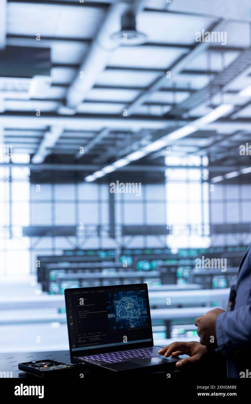 Computer scientist programming in AI server farm housing advanced equipment used for machine ...