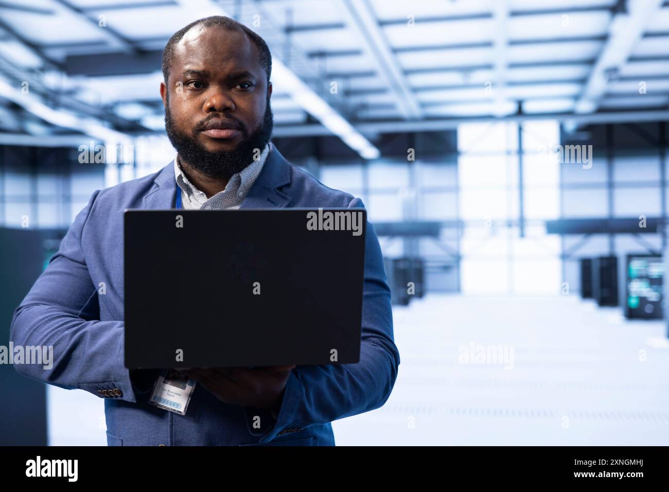 Programmer in data center using laptop to identify and solve technical ... Programmer in data center using laptop to identify and solve technical ...