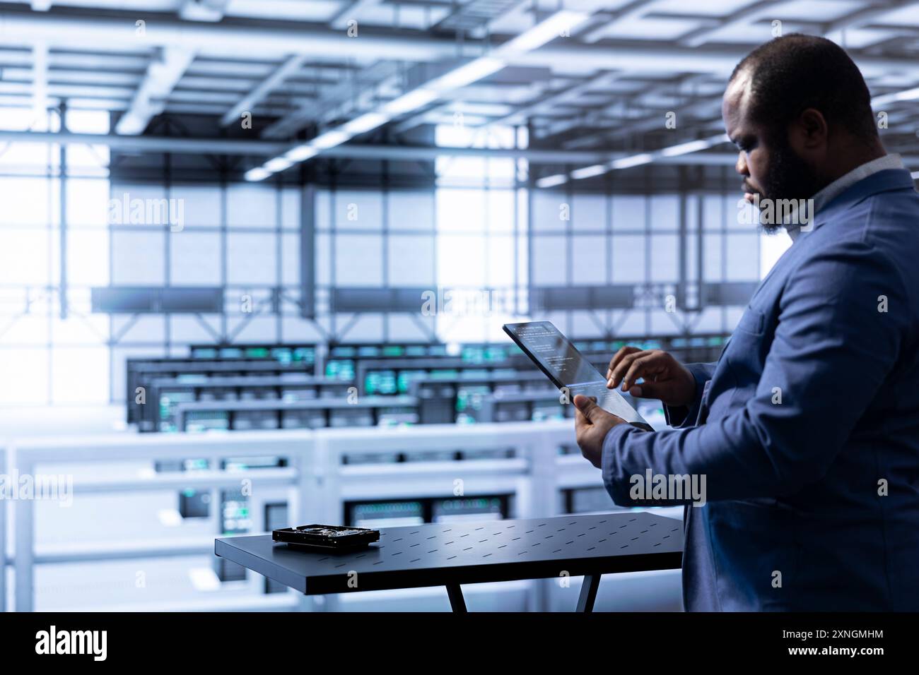 Engineer in data center using tablet to identify and solve technical issues related to data ...