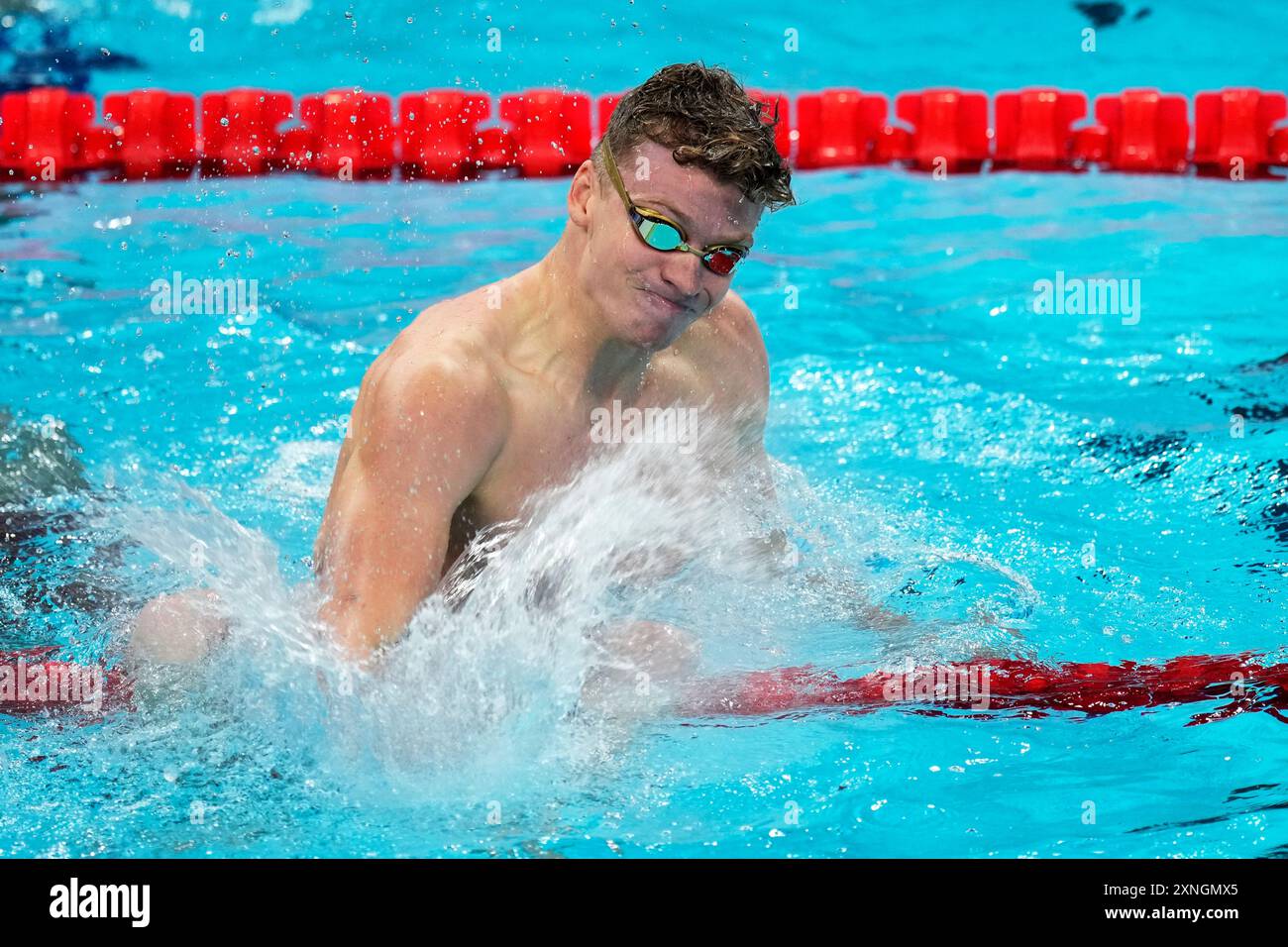 Leon Marchand, of France, celebrates after winning the men's 200-meter ...