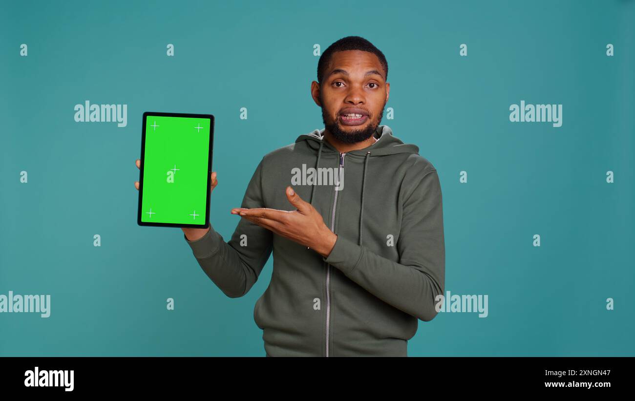 Joyous african american man holding isolated screen laptop, doing ...