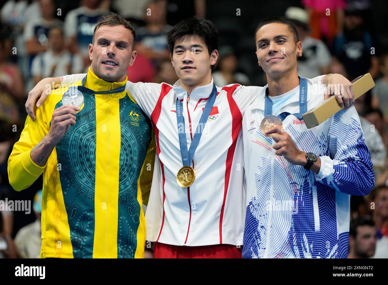 Gold medalist Pan Zhanle, center, of China, stands on the podium with ...