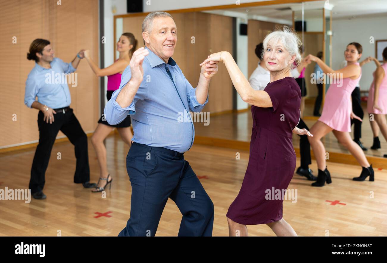 Aged couple dancing jive during group training Stock Photo - Alamy