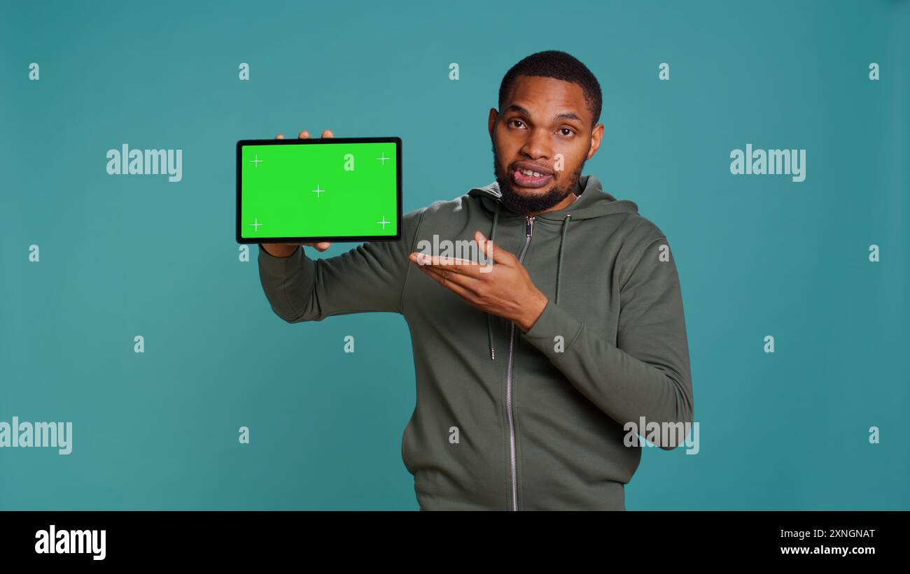 Tech content creator holding isolated screen tablet, doing promotion ...