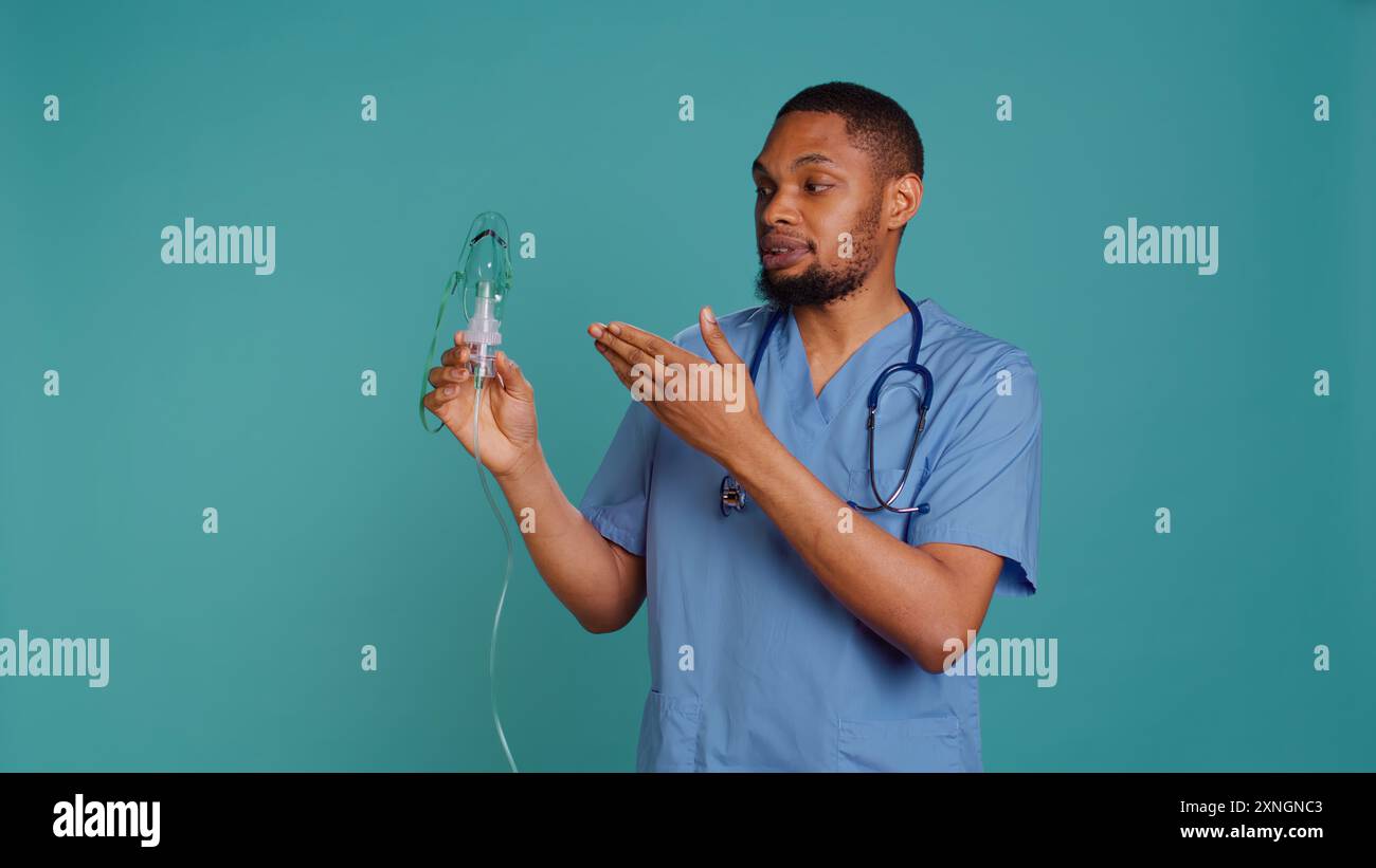 Male nurse doing medical instruction video on how to use handheld ...