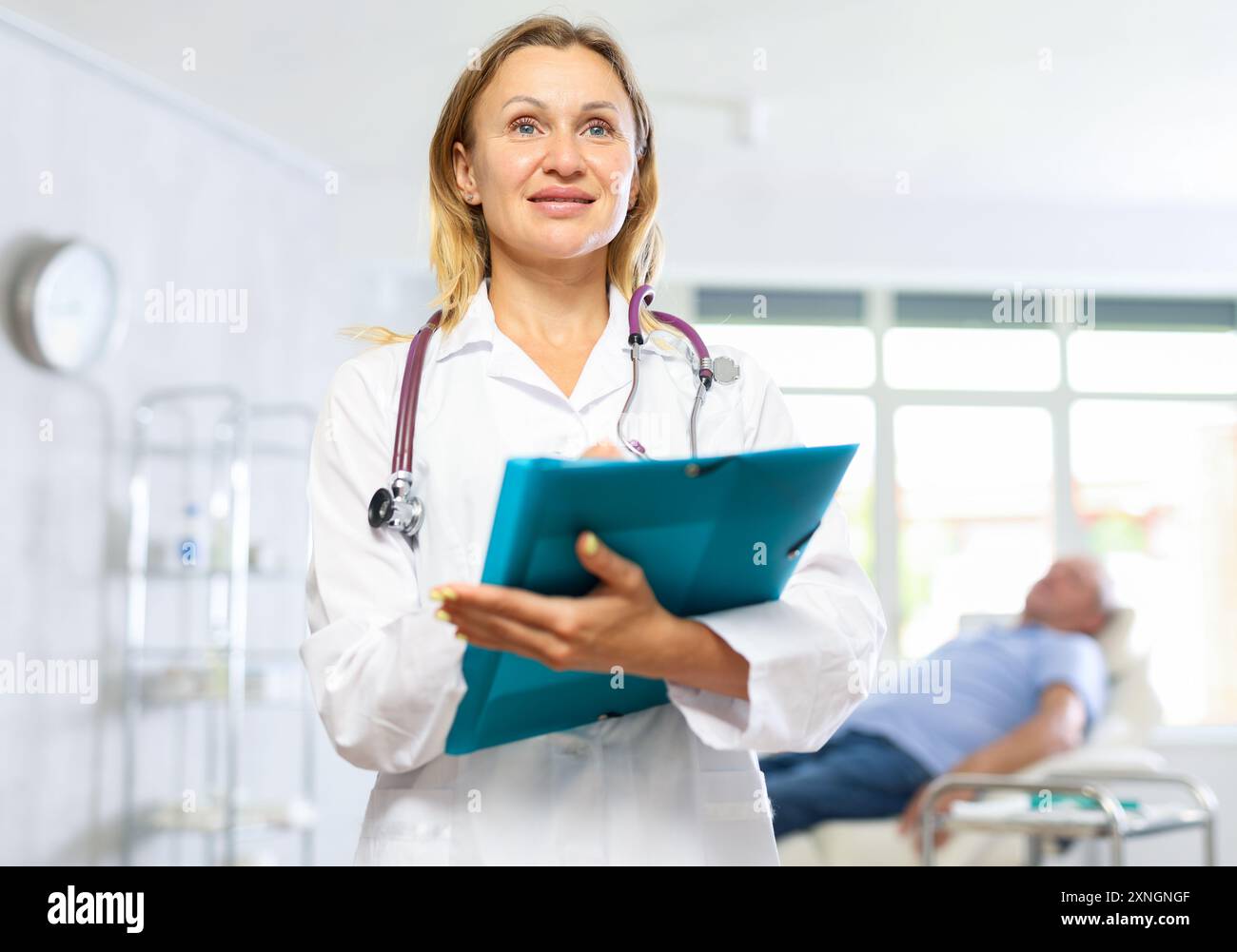 Adult woman doctor making notes in medical office Stock Photo - Alamy