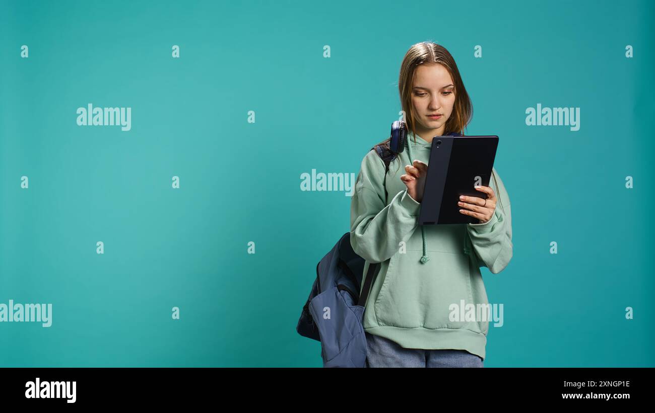 Woman scrolling on tablet touchscreen, checking social media feed ...