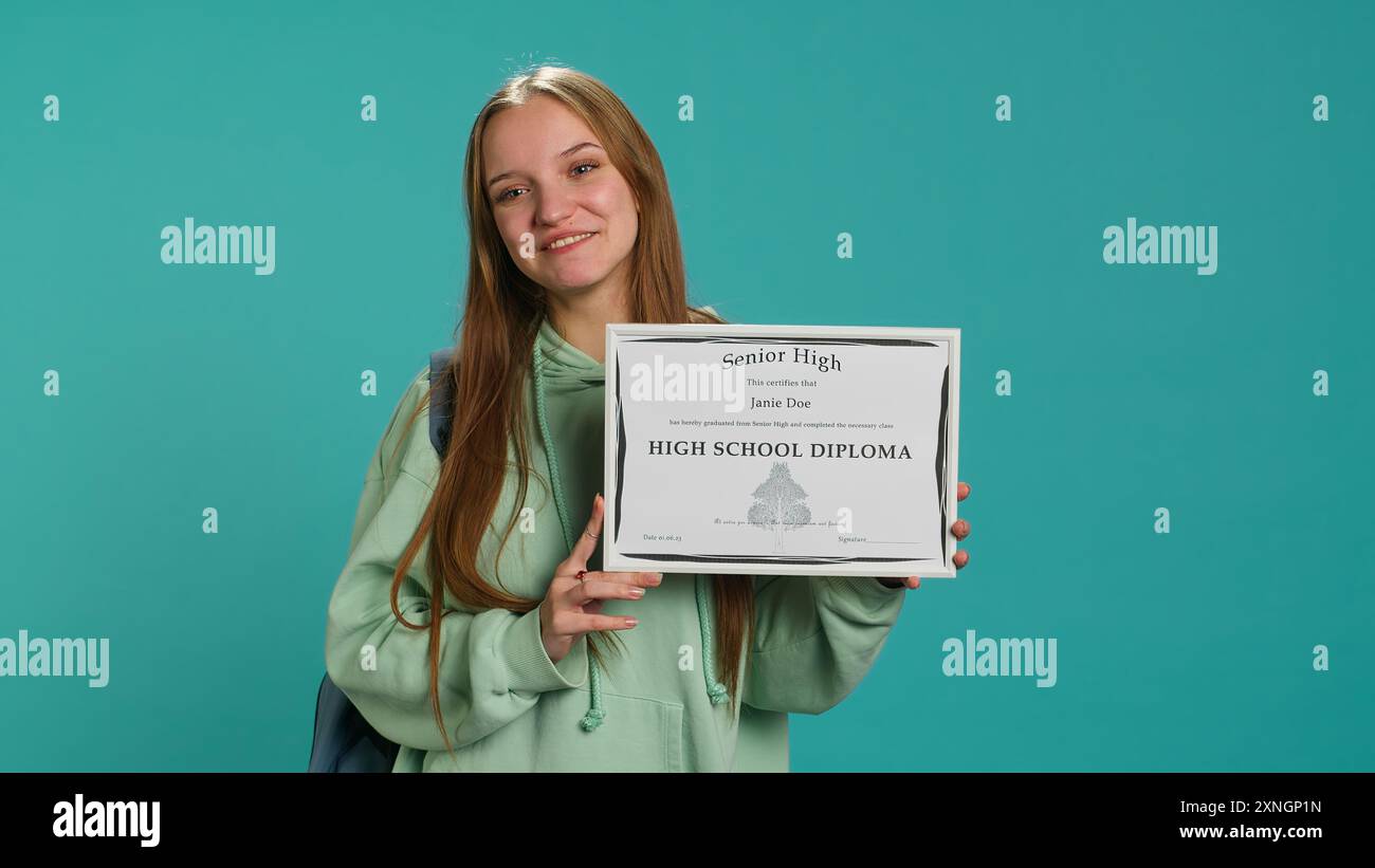 Portrait of smiling student holding high school diploma, celebrating ...