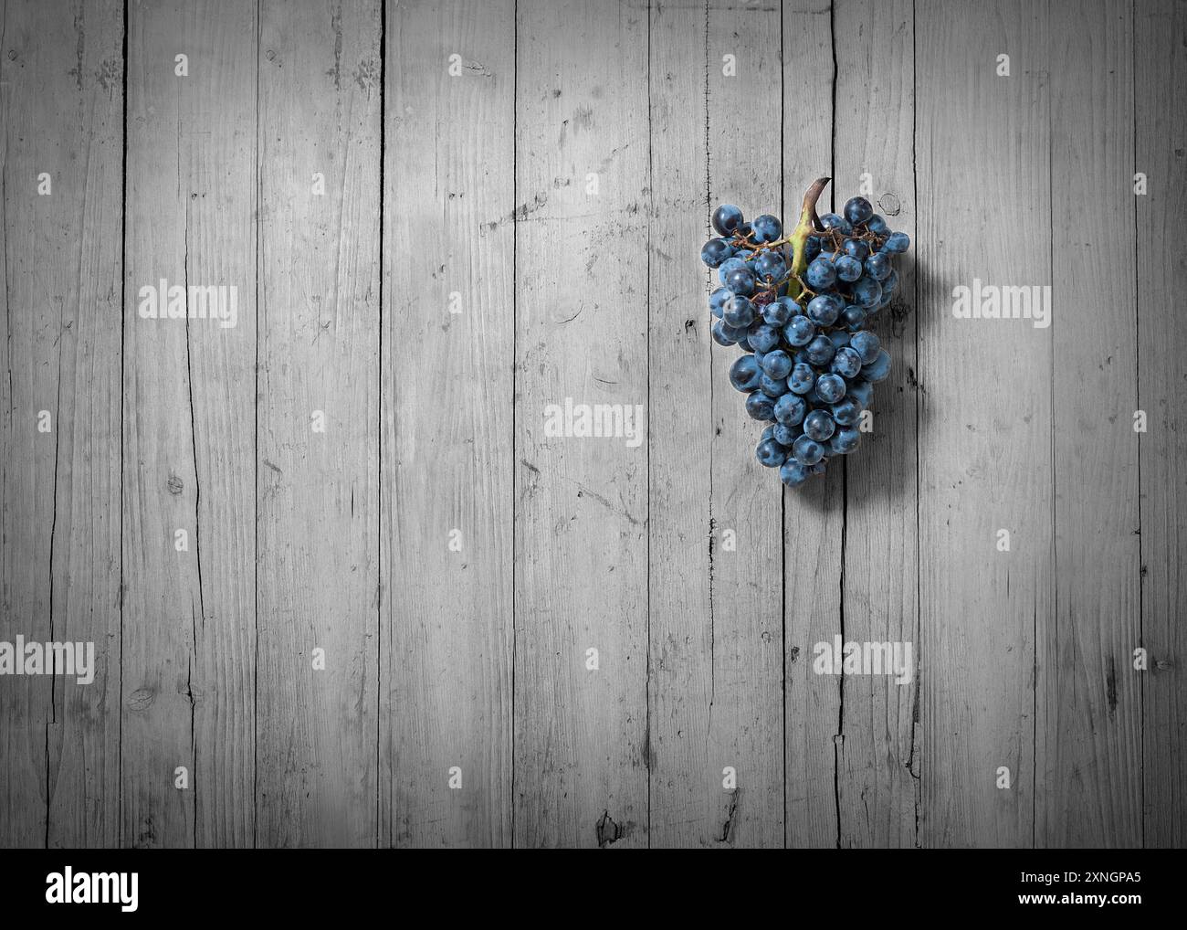 bunch of grapes on old wood and desaturated Stock Photo - Alamy