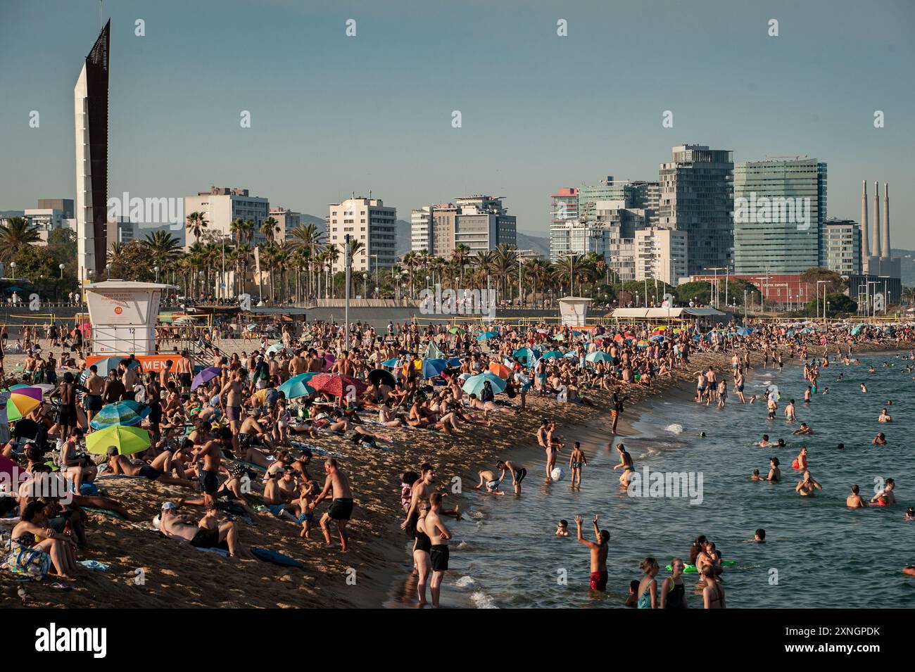July 31, 2024, Barcelona, Spain: People crowds and cool off at Bogatell ...