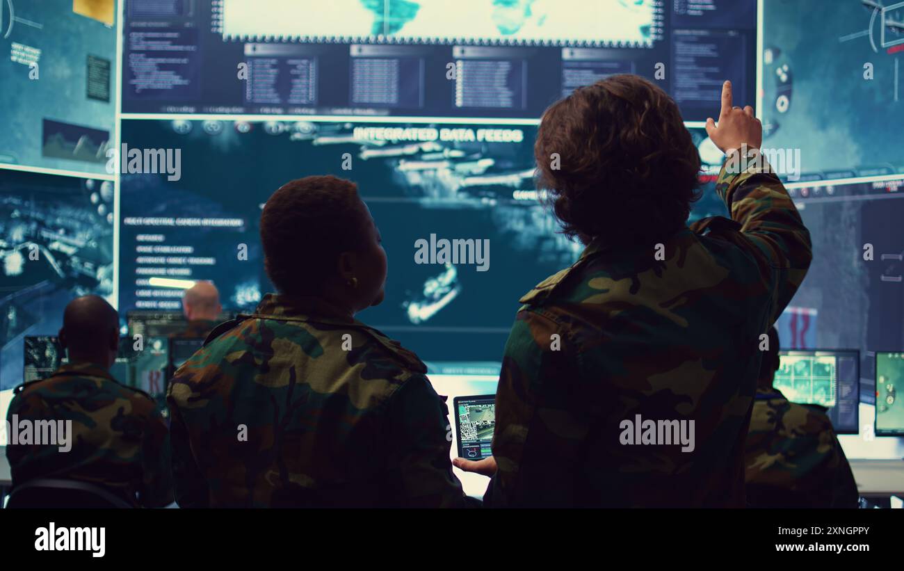 Military captains team monitoring world map via satellite CCTV footage, employing surveillance ...