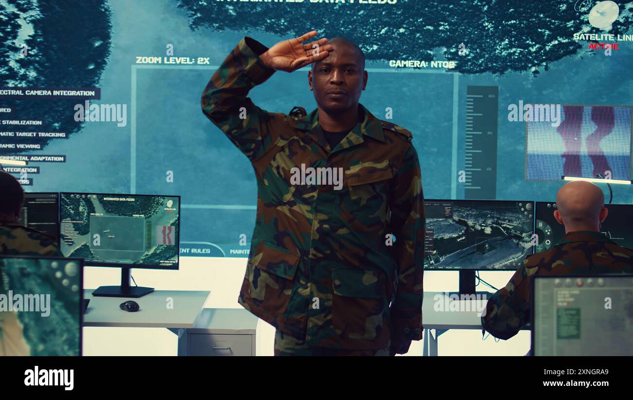 Standing at attention, the soldier executes the military salute gesture ...