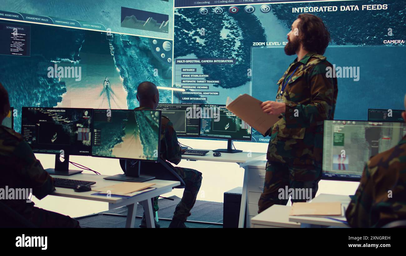 Army major reads operation details from a case file in a control center ...