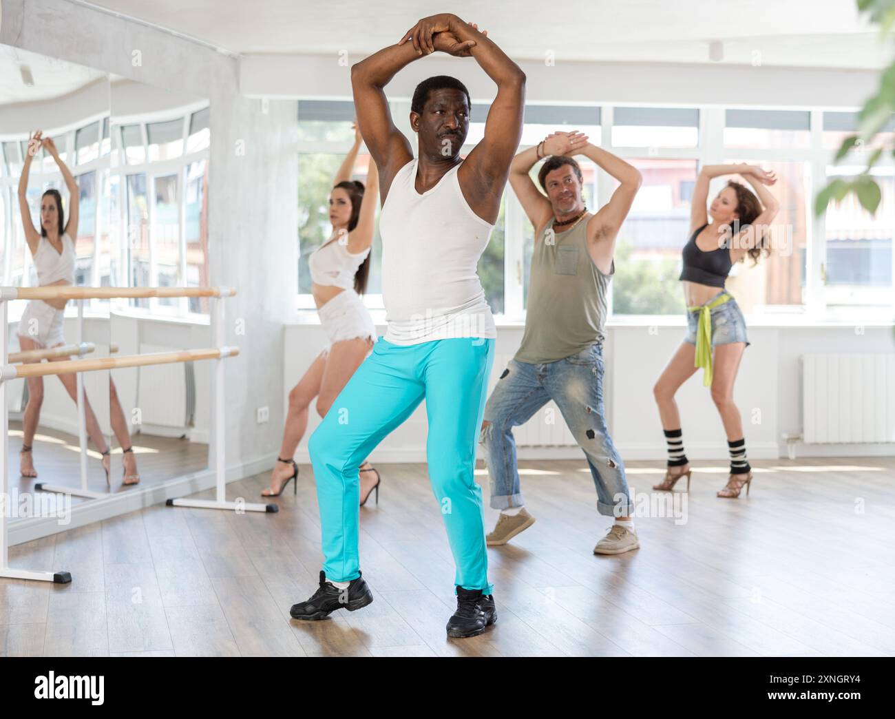 Group of men and women dancing in studio Stock Photo - Alamy