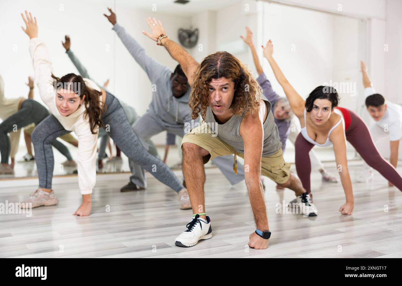 Group of active people performing a stretching exercise Stock Photo - Alamy